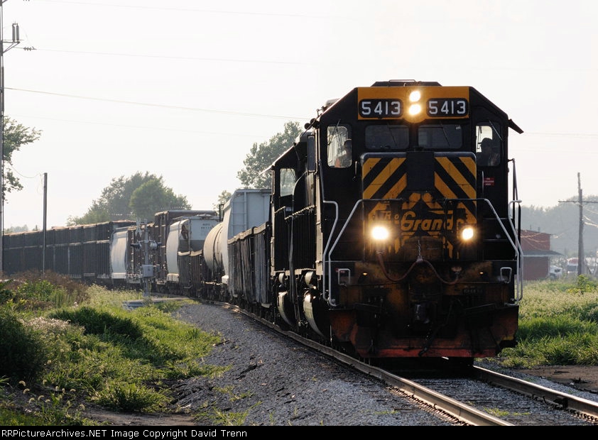 WLE (DRGW) 5413 heads West (heavily backlit by the sun) now on home rails at Bellvue Ohio